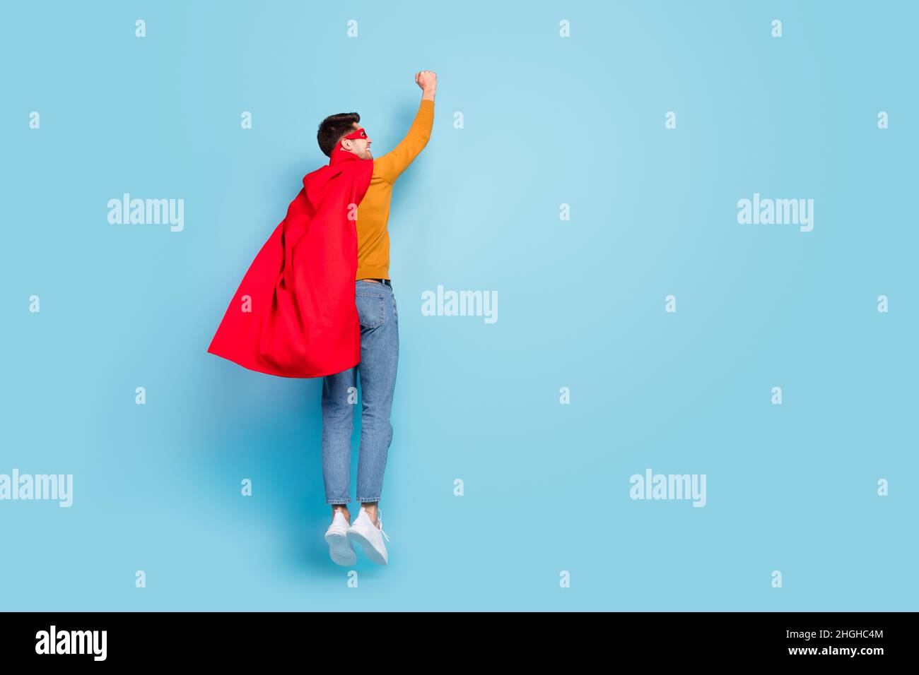 Back view full length photo of young superhero jump fly air help ...