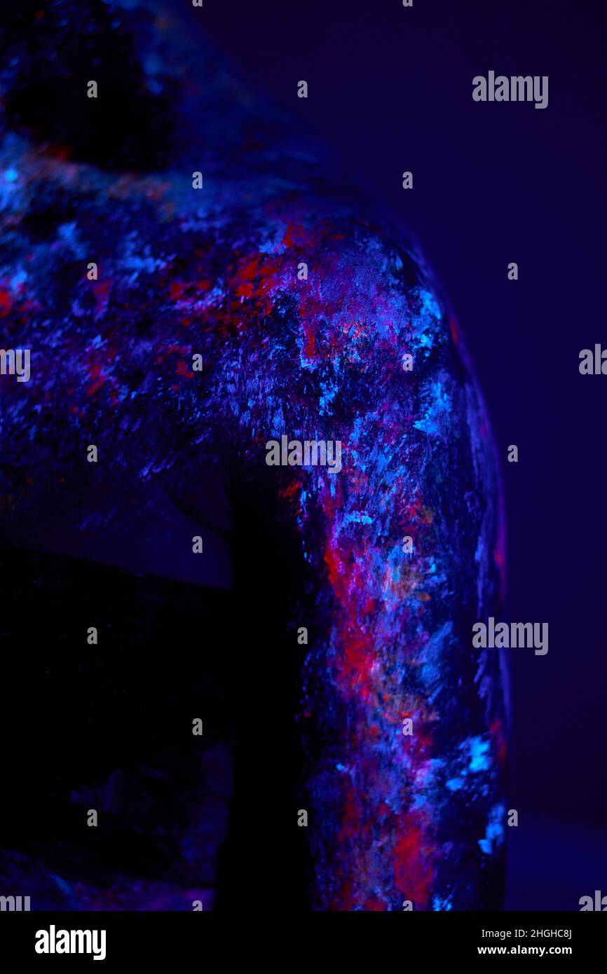Close-up photo of female skin with fluorescent paintings, body art make ...