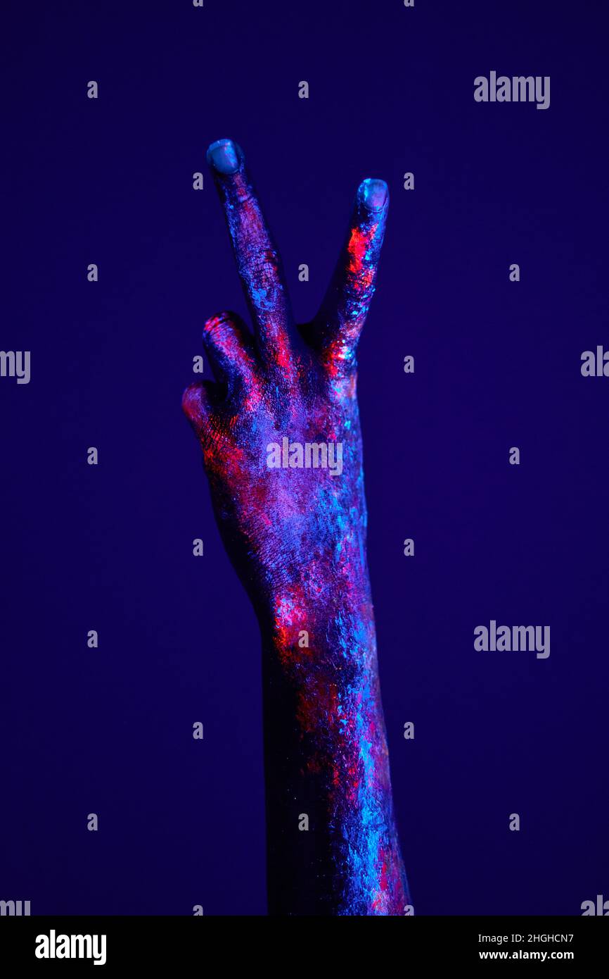 Close up hand with fluorescent paintings powder show finger number two ...
