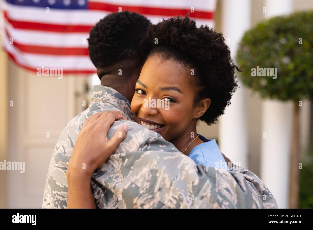 Portrait of smiling african american hugging military soldier on his ...