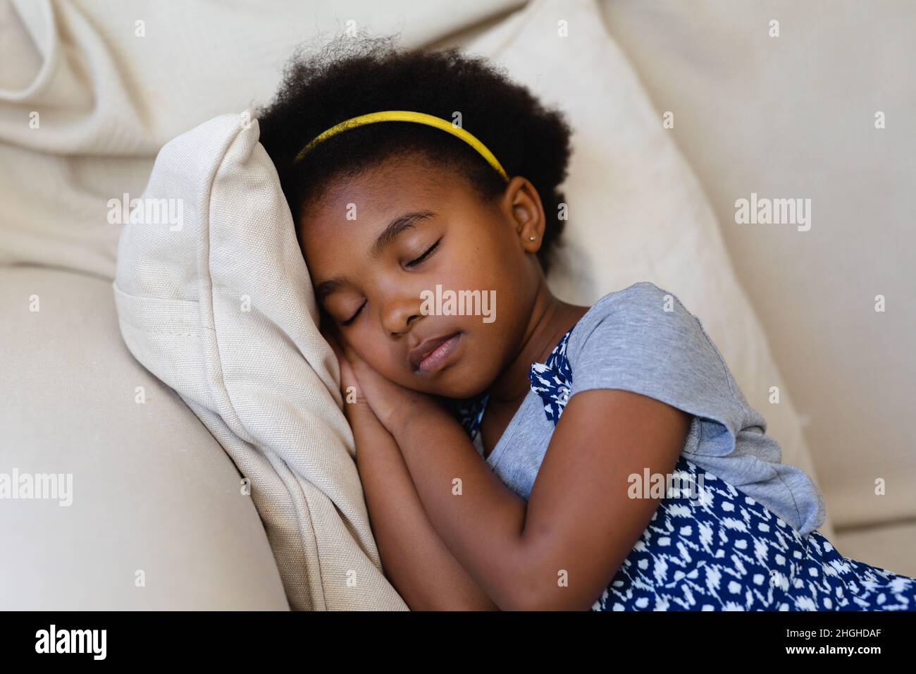 Cute african american girl sleeping on the couch at home Stock Photo ...