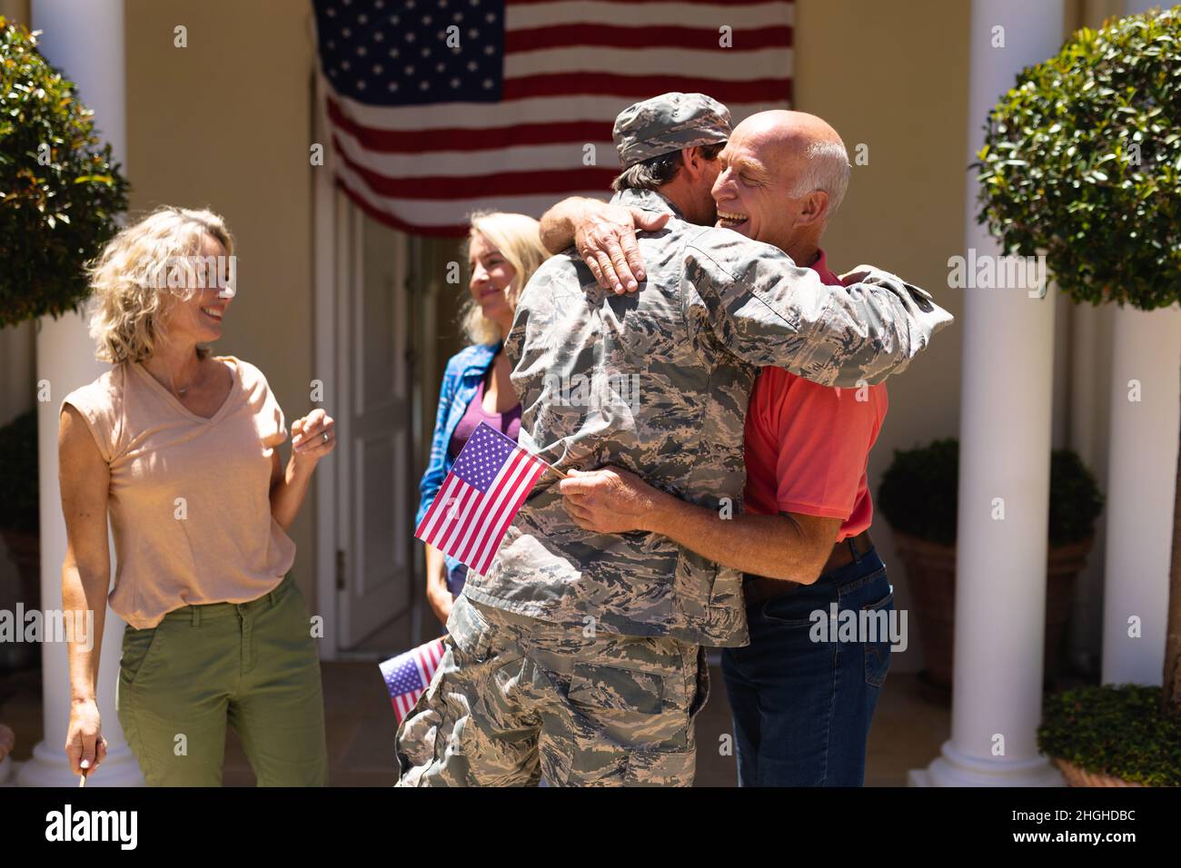 Happy caucasian father hugging soldier on his return with family ...