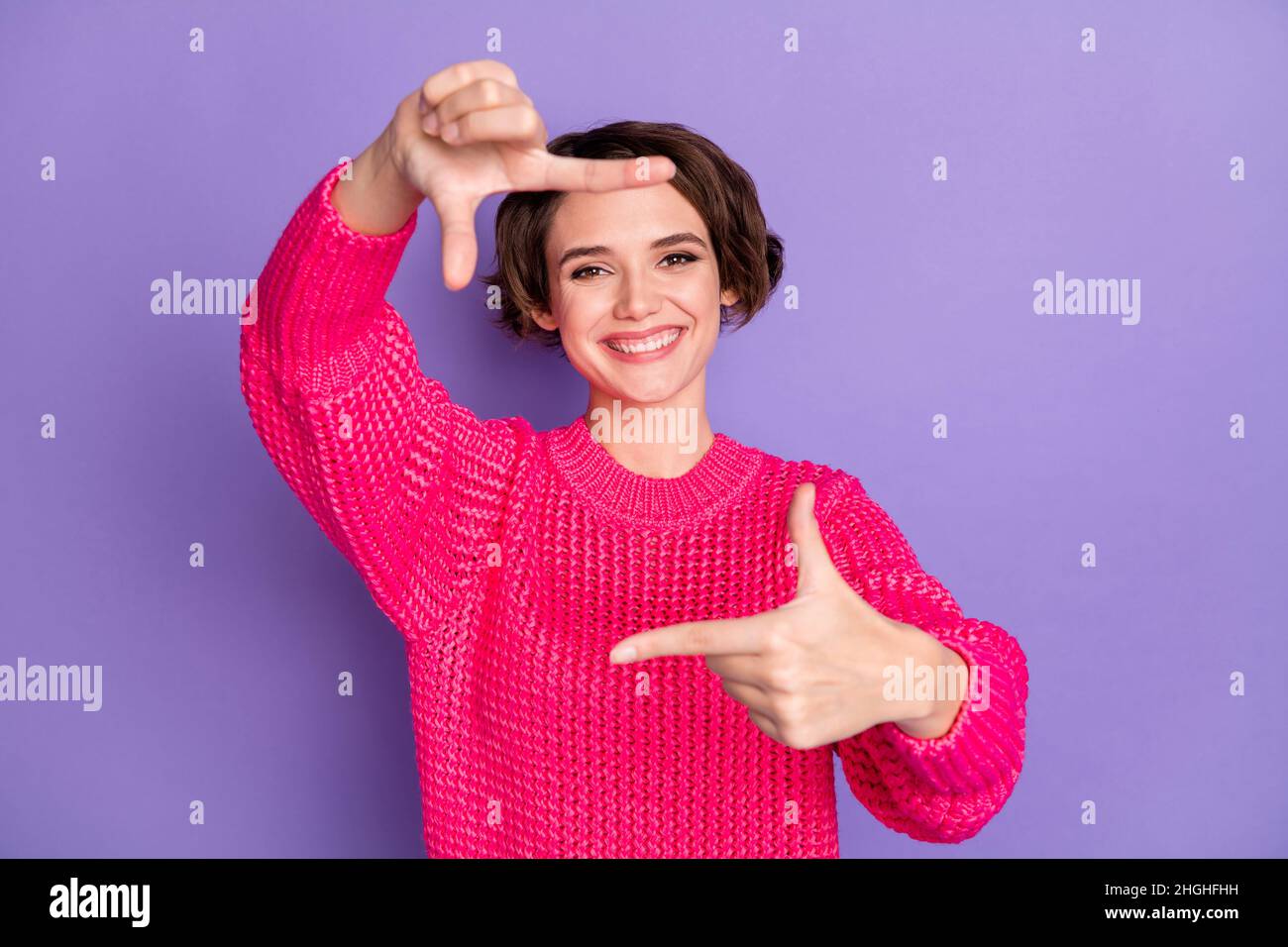 Portrait of cheerful pretty lady arms fingers show frame beaming smile ...