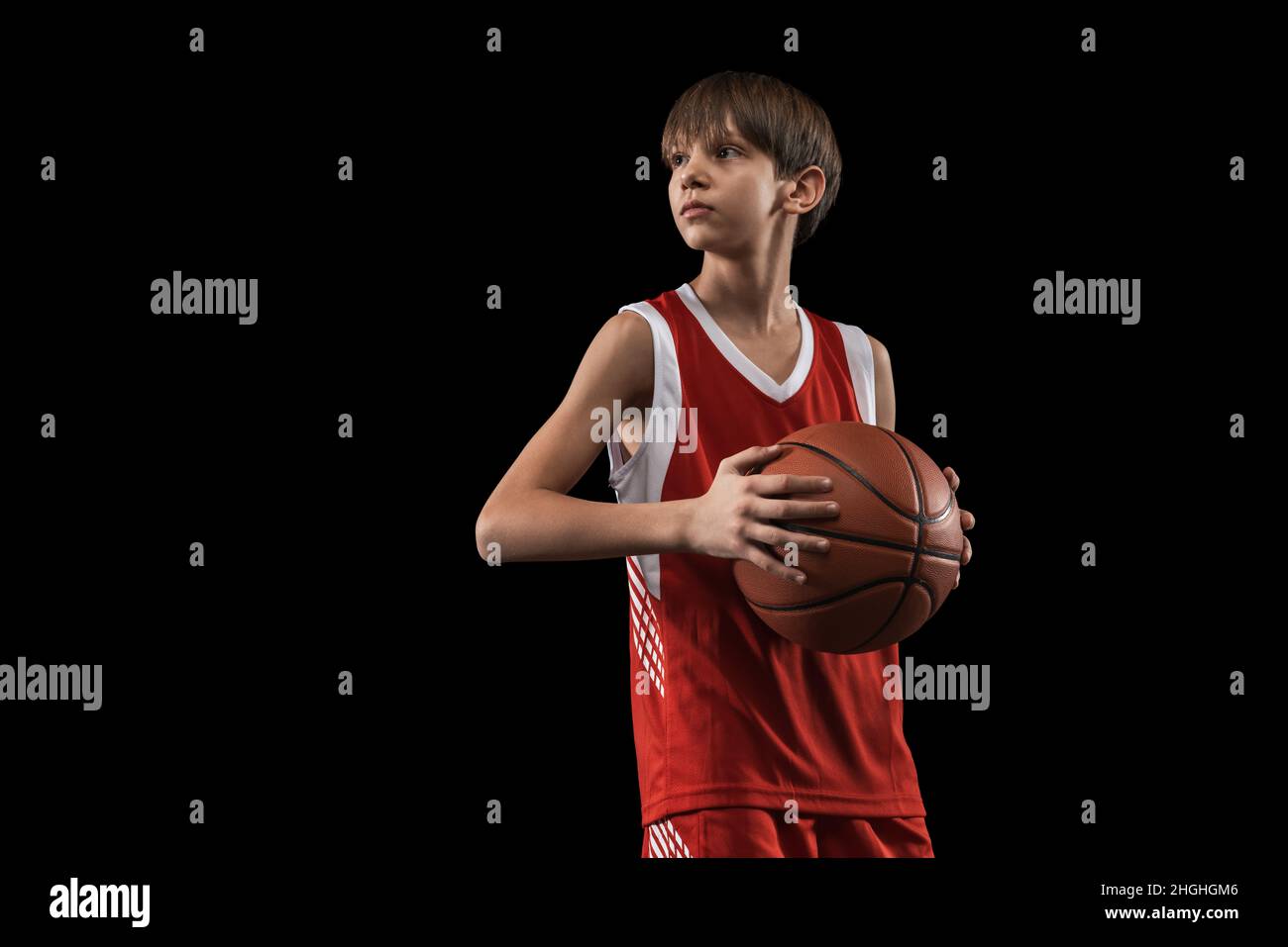 Cropped portrait of young boy, basketball player in red uniform ...