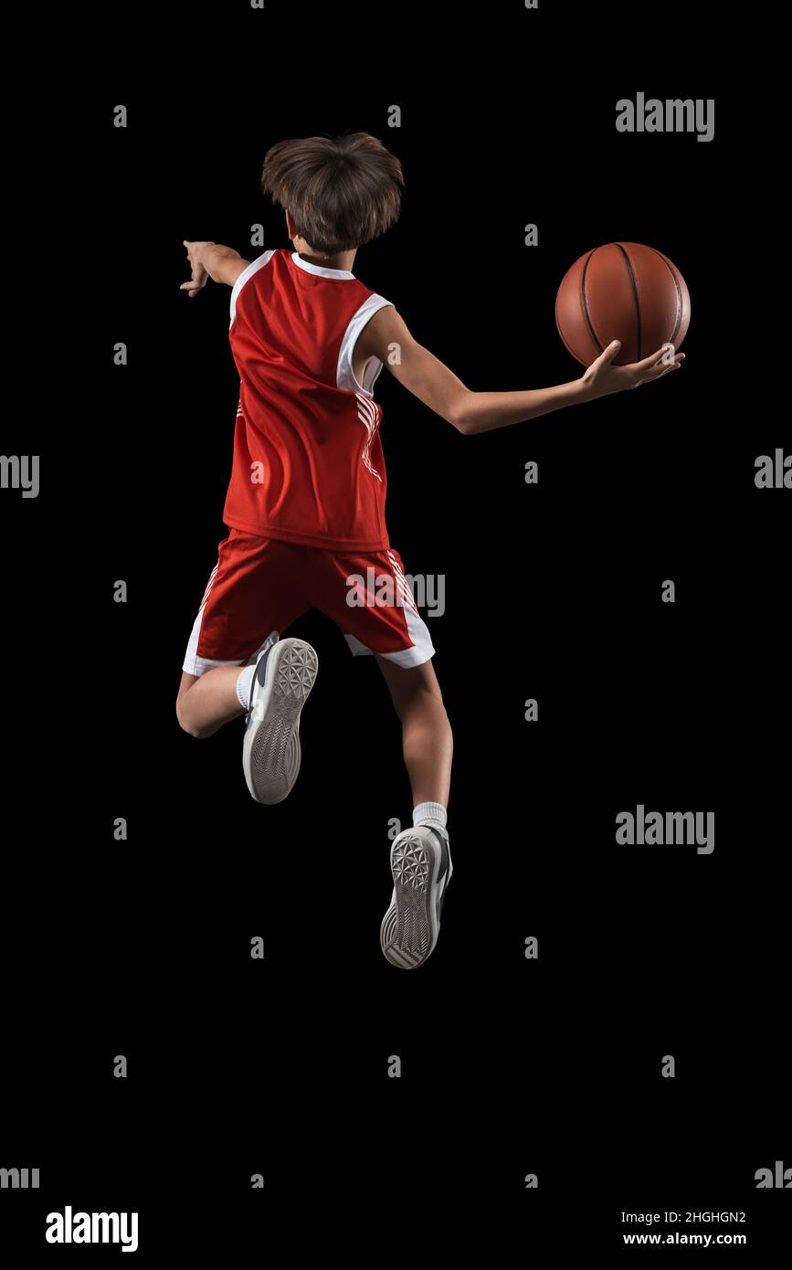 Full-length studio shot of basketball player in motion, jumping and ...
