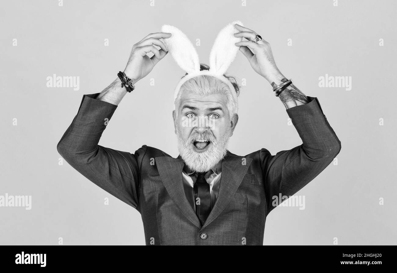 Having fun. Bearded man bunny ears on head. Funny boss. Easter ...