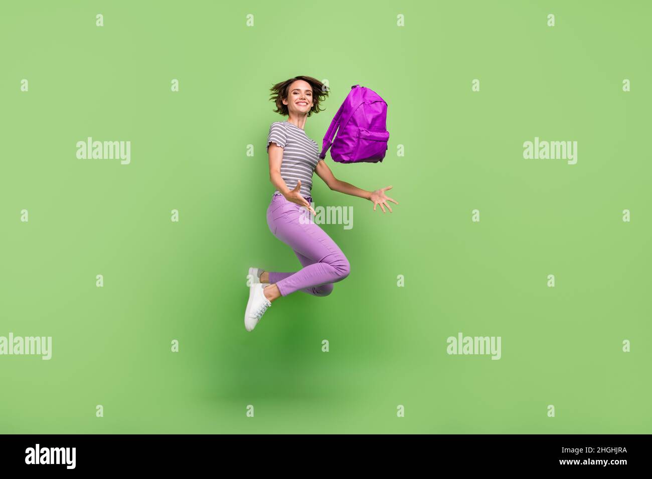 Photo of pretty shiny young woman dressed striped t-shirt throwing ...