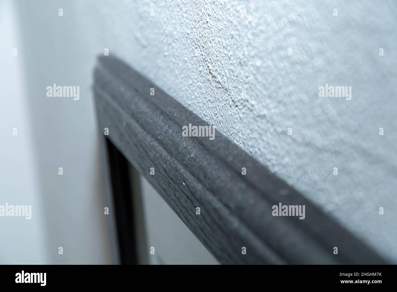 dusty black picture frame on the wall Stock Photo - Alamy