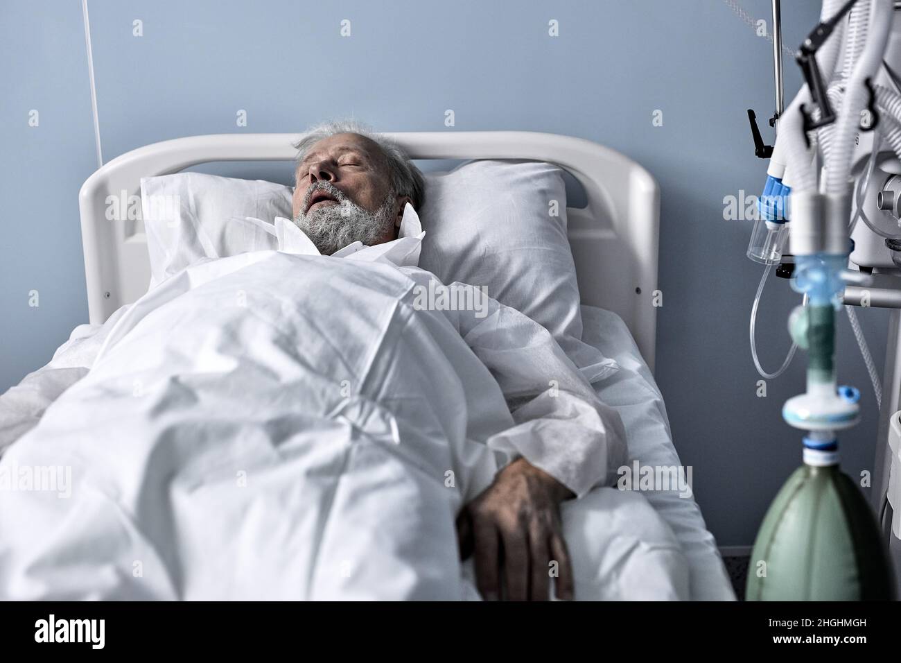caucasian senior man patient lying on bed at hospital ward. Lonely old ...