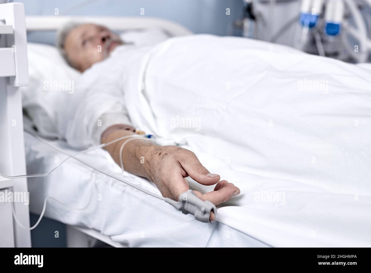 sick senior male patient in hospital bed. Healthcare and treatments ...