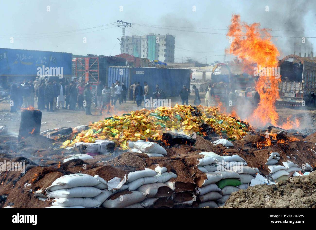 View of destroying liquor bottles and burning pile of confiscated drugs ...