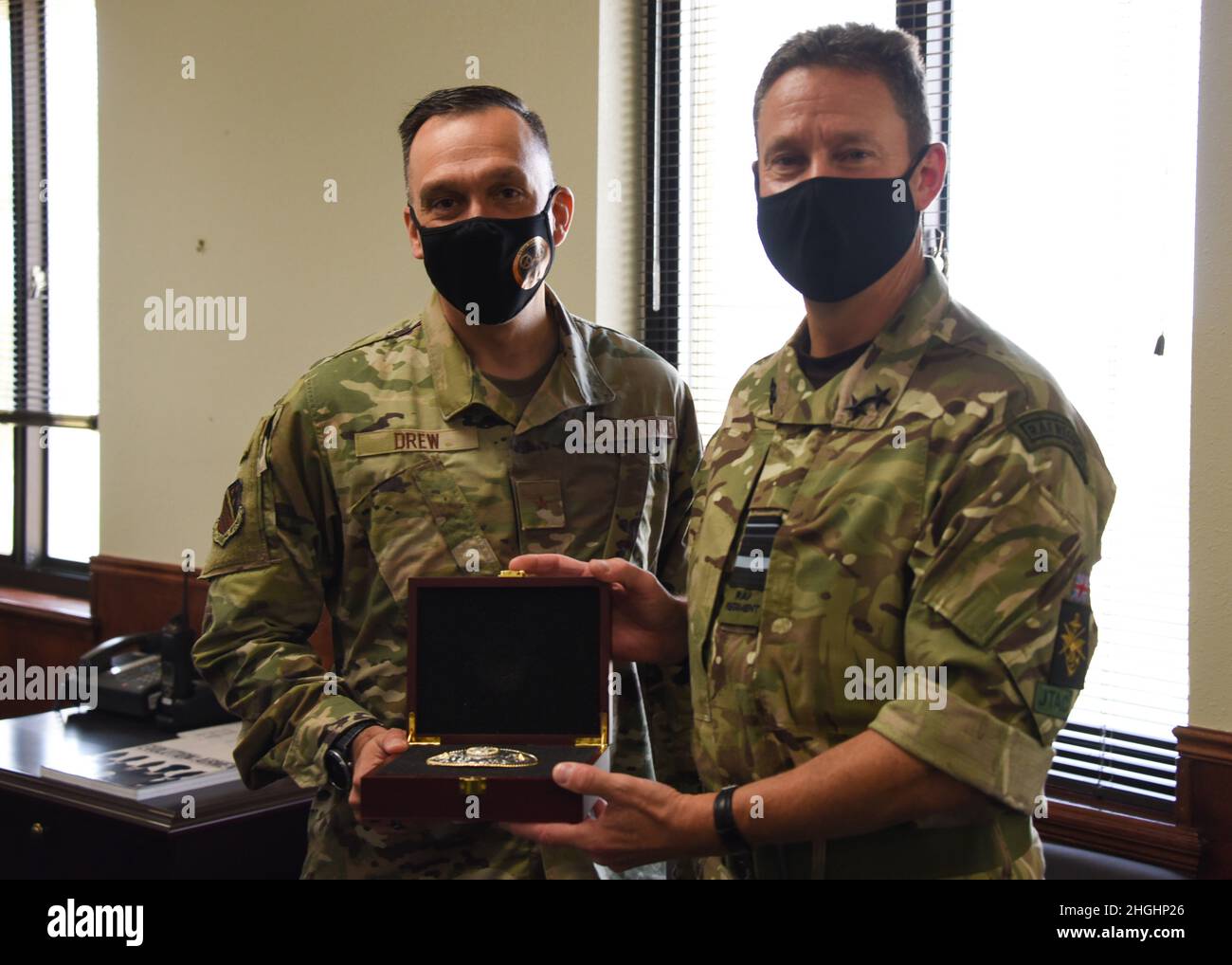 Air Vice-Marshal Mick Smeath (right) receives a gift from installation ...