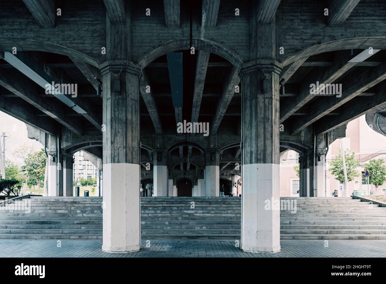 Old stone bridge structure from below in Bilbao city. Cold blue effect ...