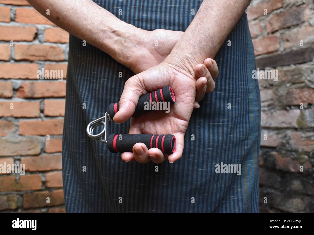 Southeast asian, Myanmar old man gripping hand exercise gripper Stock ...
