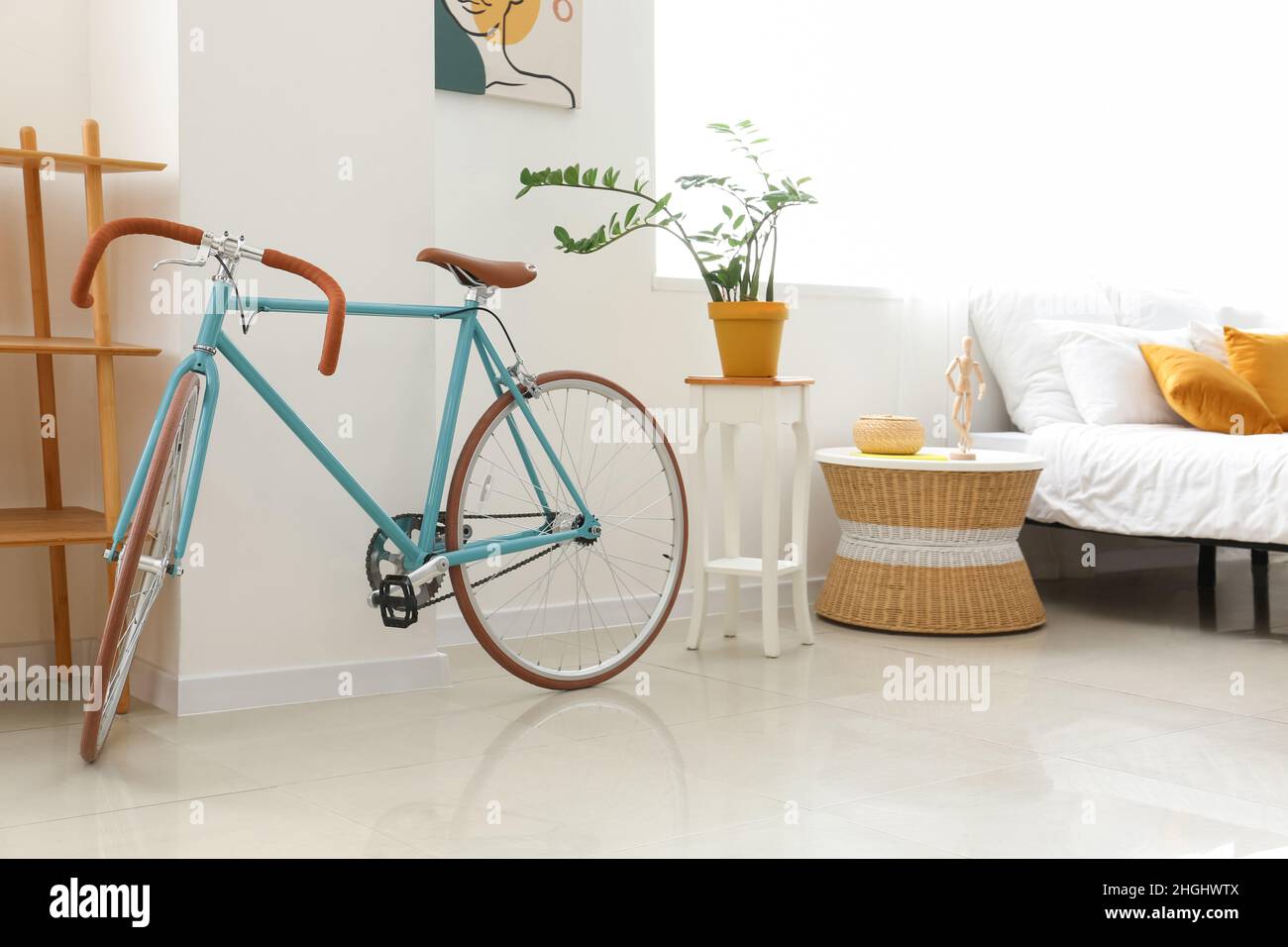 Interior of stylish bedroom with bicycle Stock Photo - Alamy