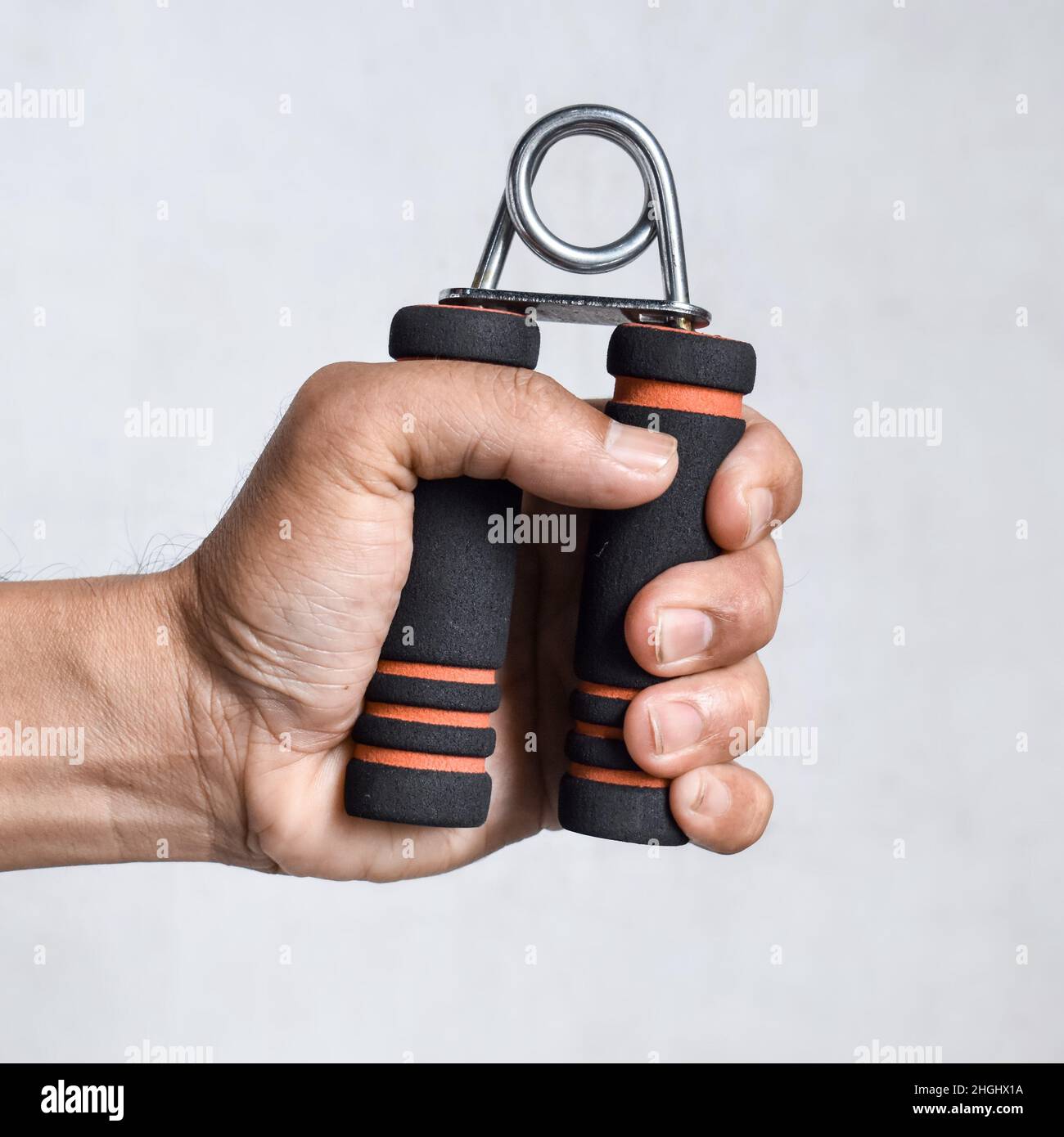 Hand of Southeast asian, Chinese man gripping hand exercise gripper ...