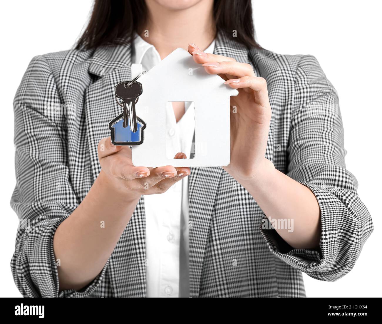 Real estate agent with figure of house and key on white background ...