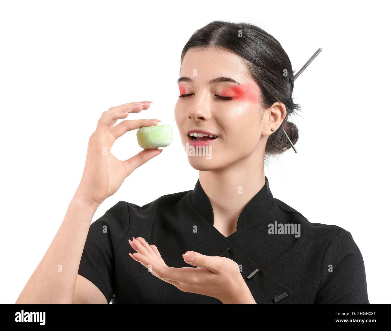 Beautiful young woman eating tasty Japanese mochi isolated on white ...