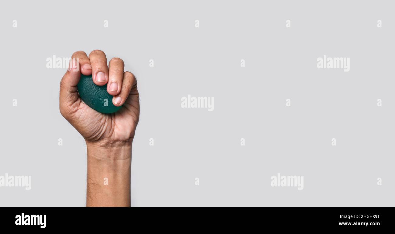 Southeast asian, Chinese man gripping hand exercise elastic ball Stock ...