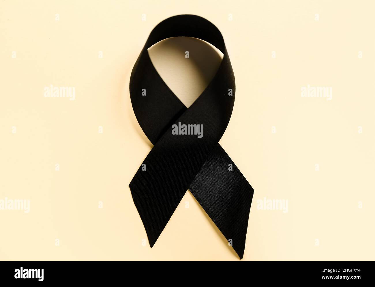 Black ribbon on color background. Melanoma concept Stock Photo - Alamy