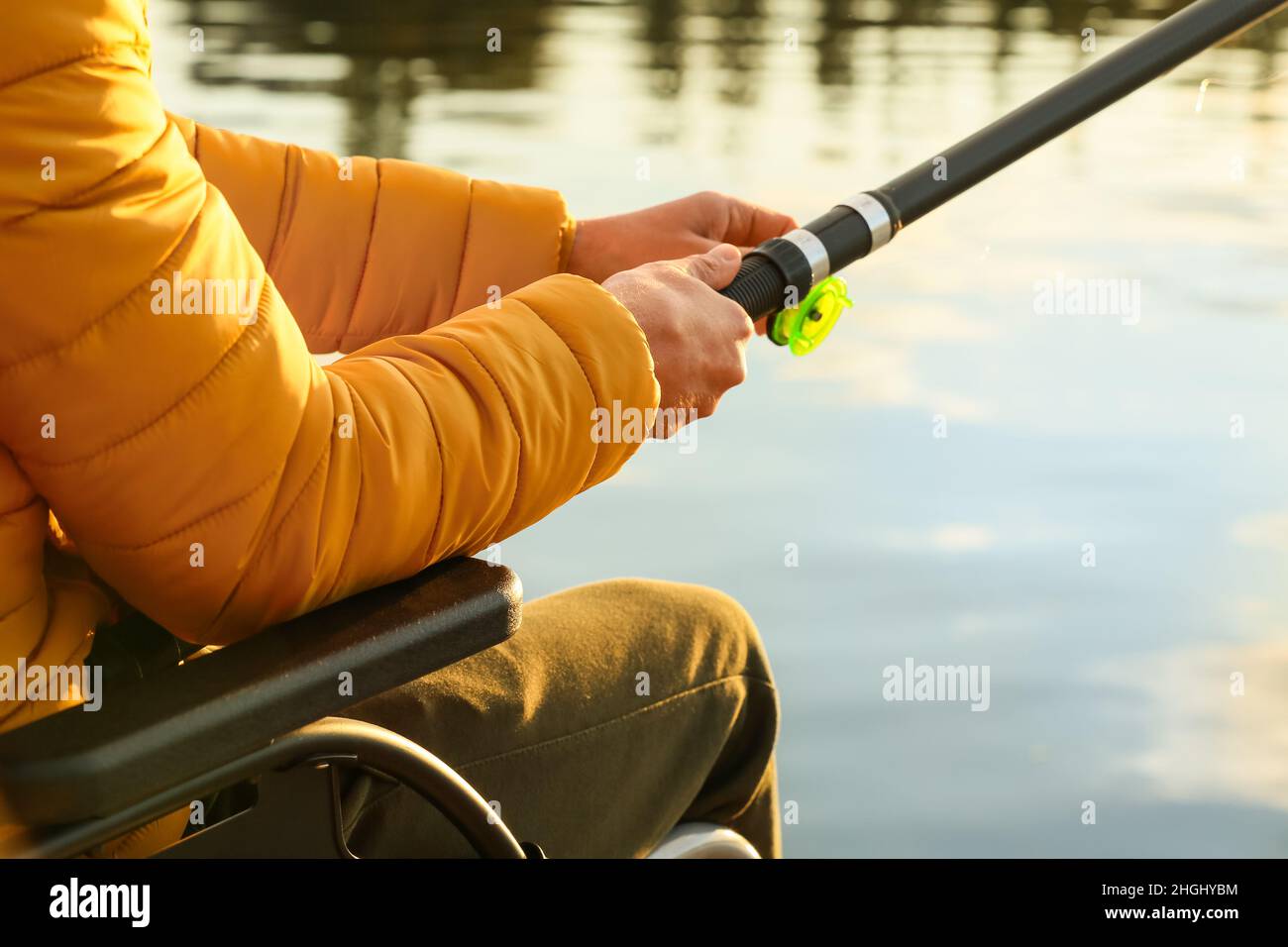 Man in wheelchair fishing on river Stock Photo - Alamy