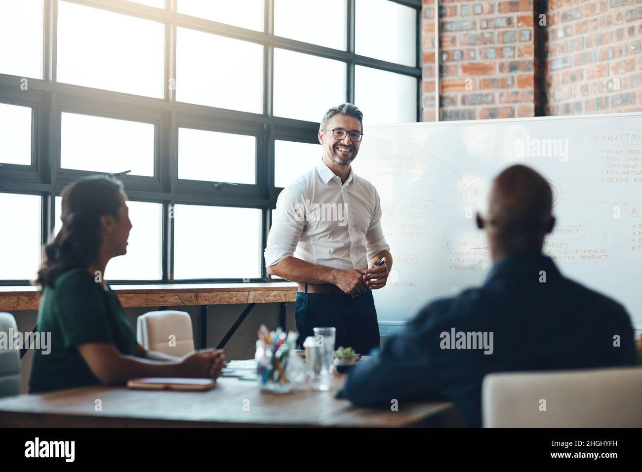 Sharing important updates with the team. Shot of a businessman giving a ...