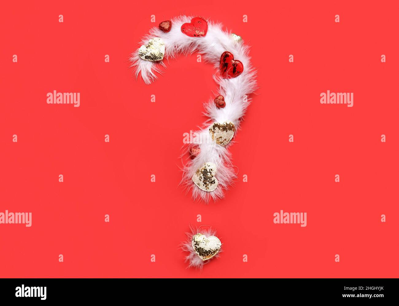 Question mark made of feathers and little hearts on color background ...