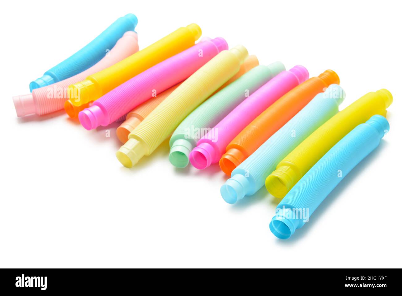 Different colorful Pop Tubes on white background Stock Photo - Alamy