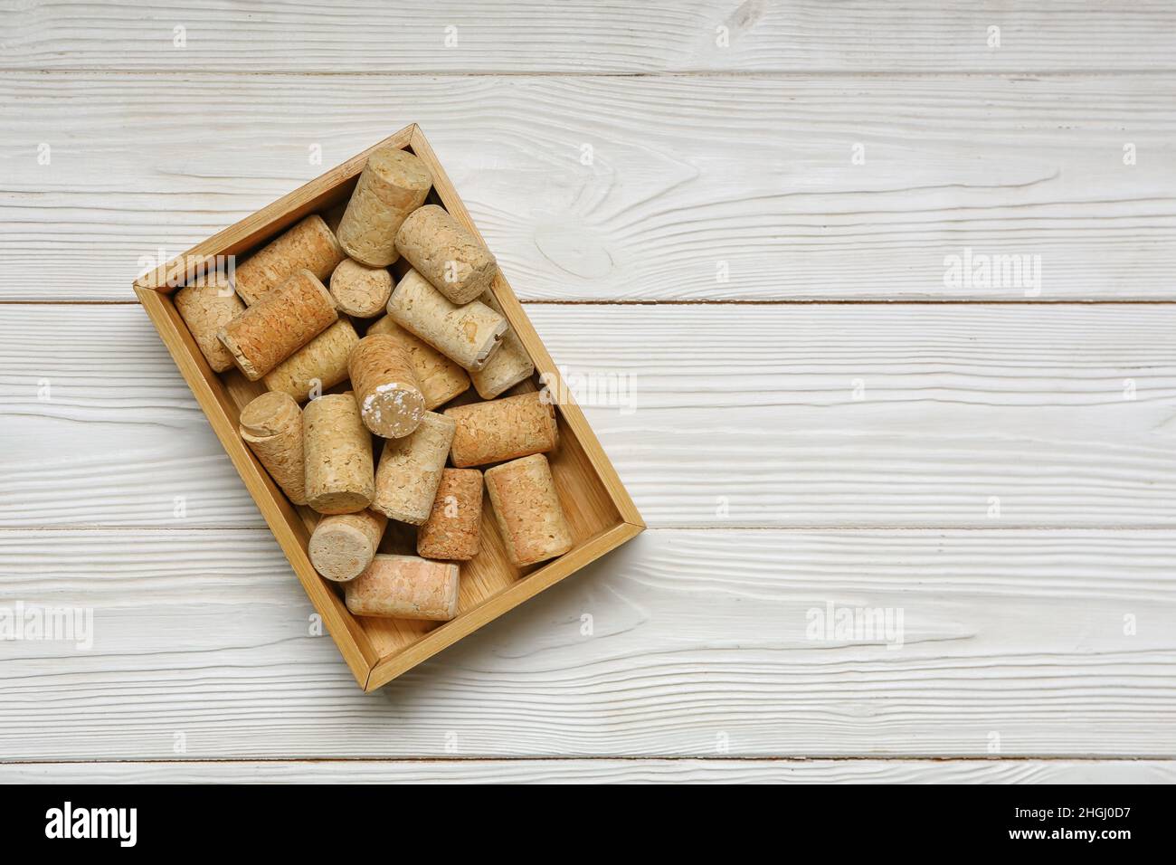 Box with wine corks on white wooden background Stock Photo - Alamy