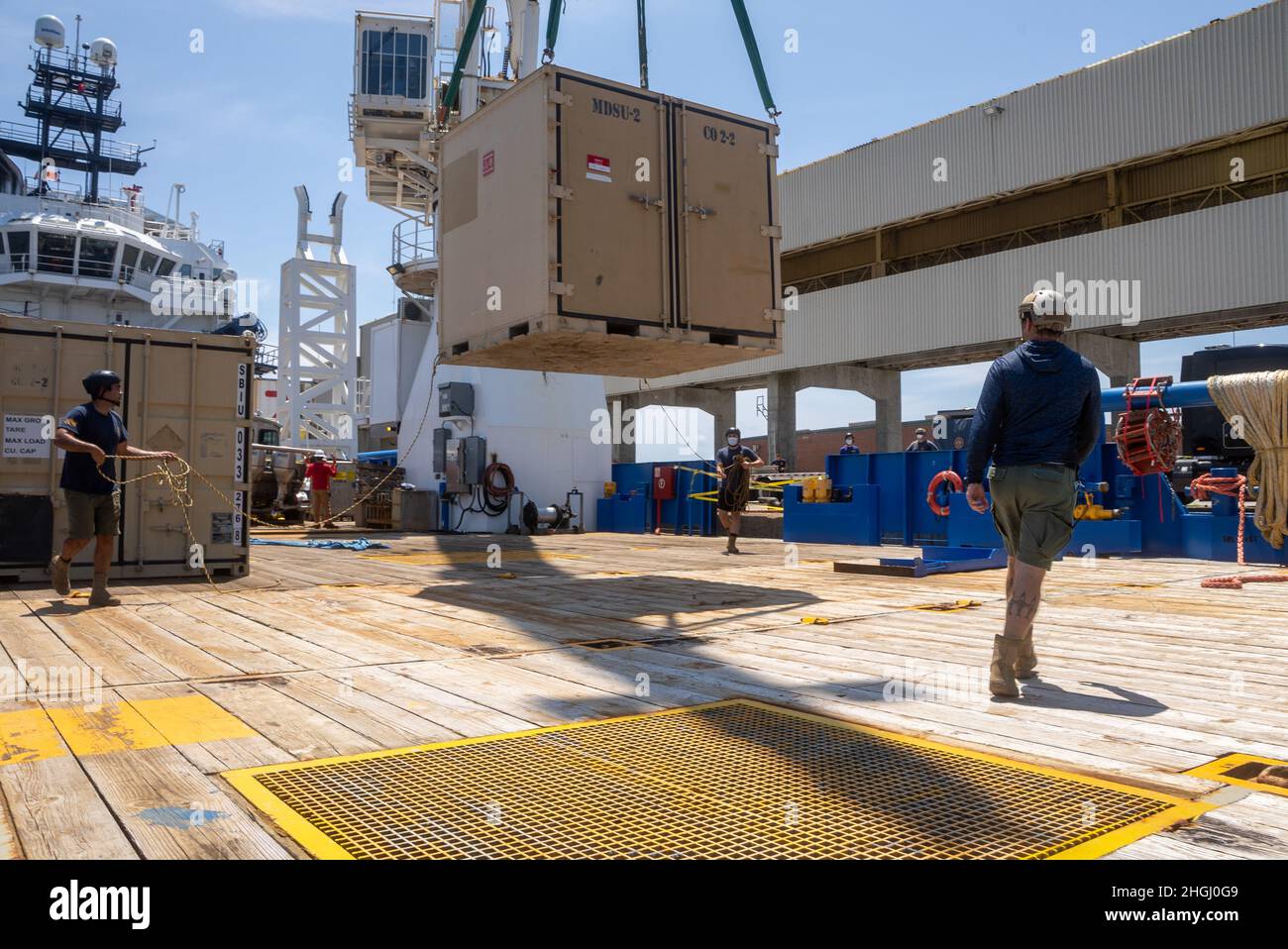 Navy Divers, assigned to Mobile Diving Salvage Unit (MDSU) 2, load an ...