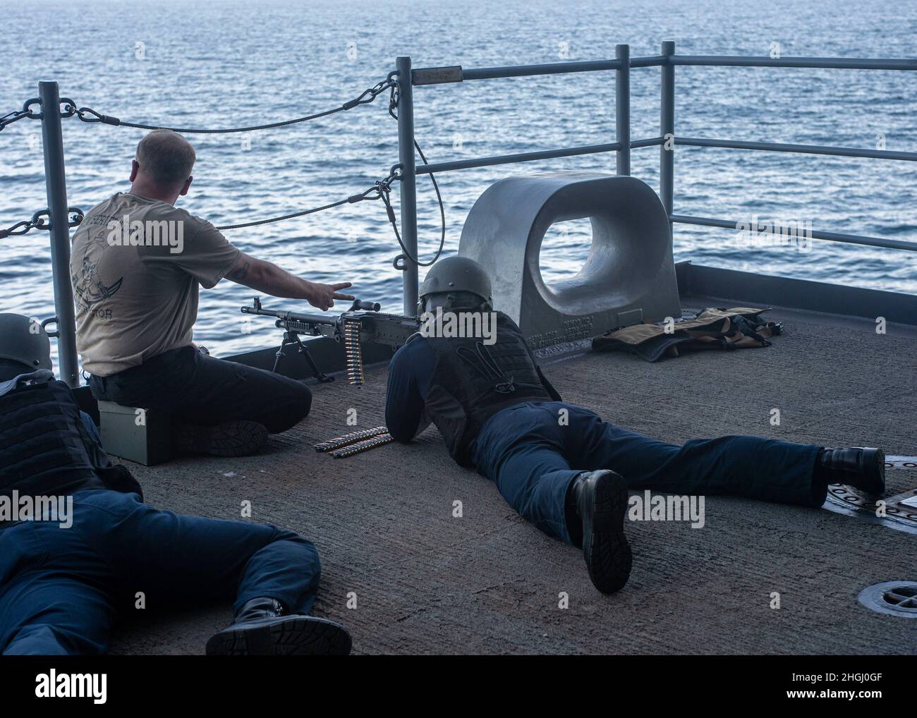 Gunner's Mate 1st Class Dustin Jones, center, from Dayton, Ohio ...