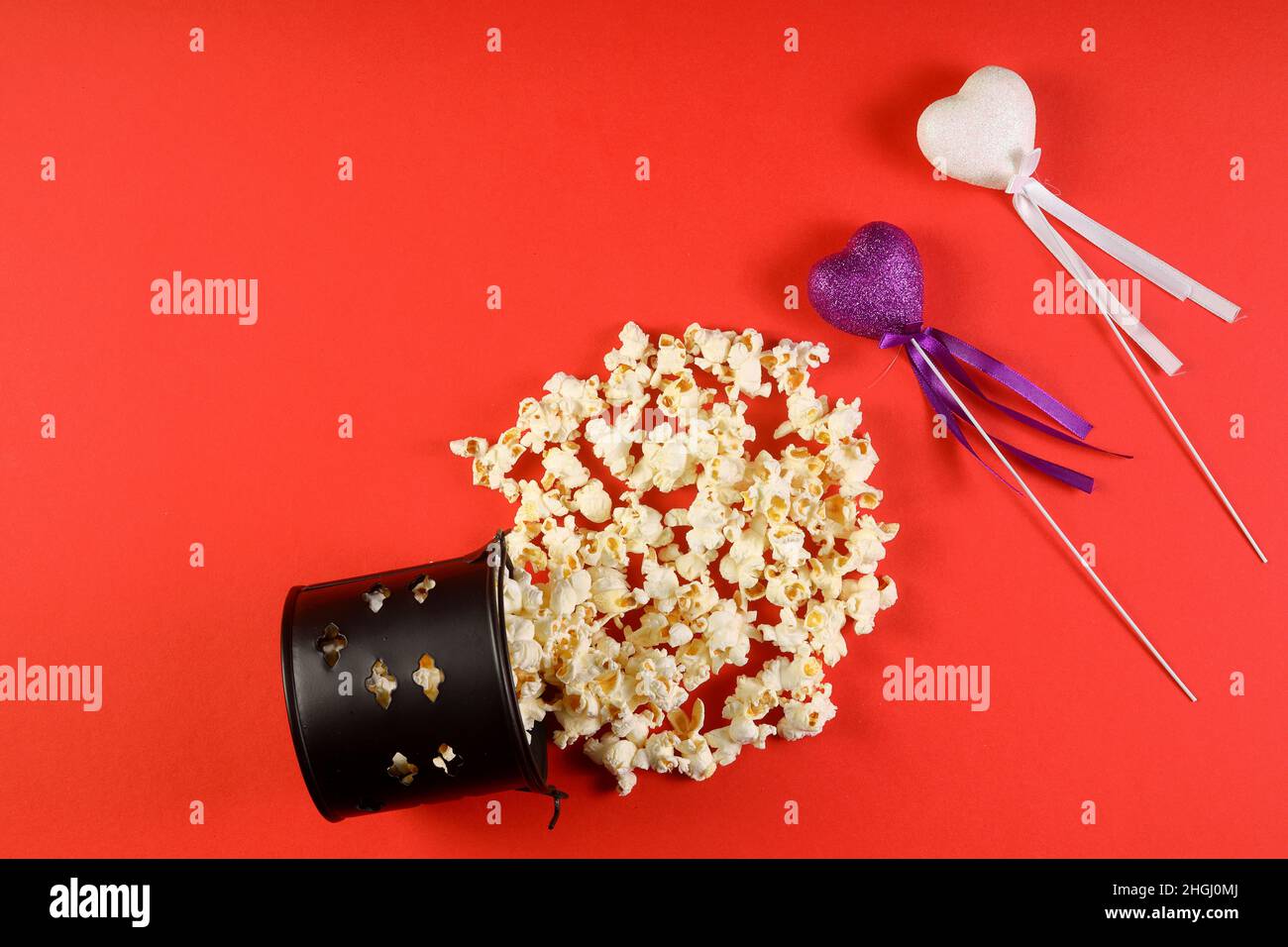 Love cinema concept of popcorn. Heart shaped white fluffy popcorn on ...
