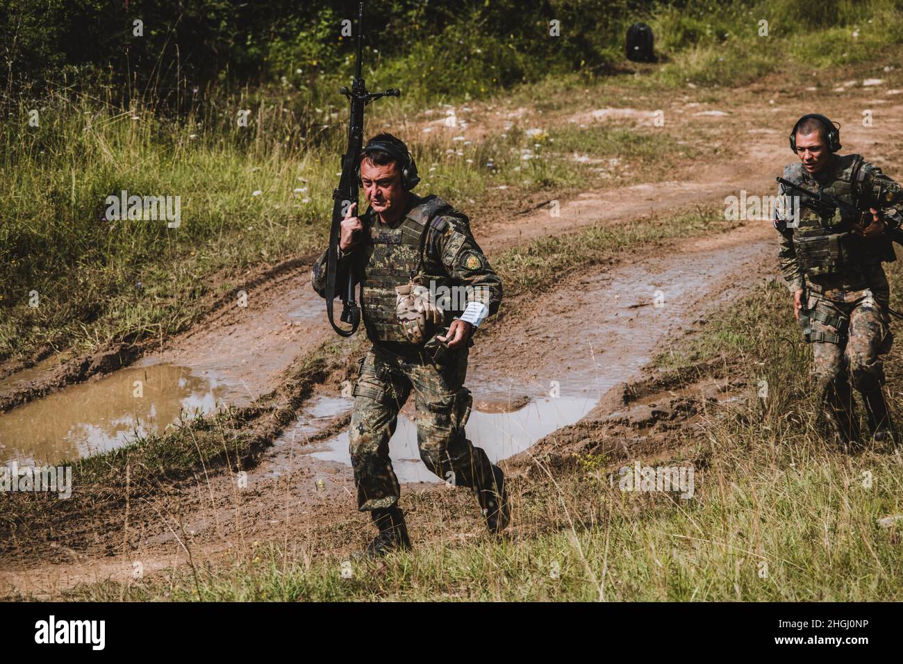 A Bulgarian sniper team relocates as simulated artillery is fired on ...