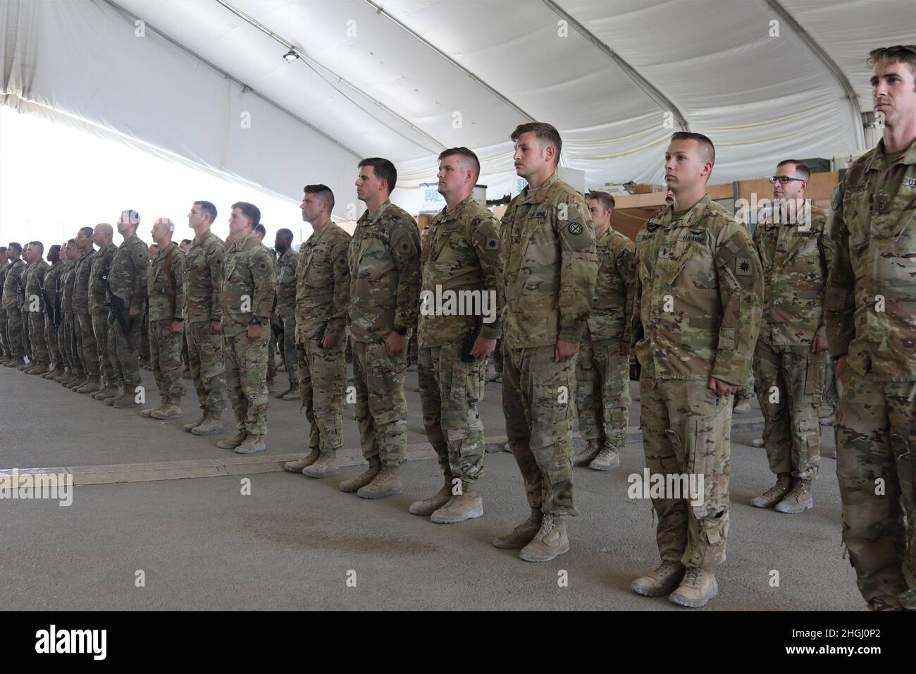 Task Force Wolfpack Soldiers stand at attention during a combat patch ...