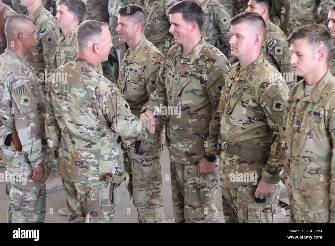Task Force Phoenix Commander Col. Alan Gronewold congratulates a ...