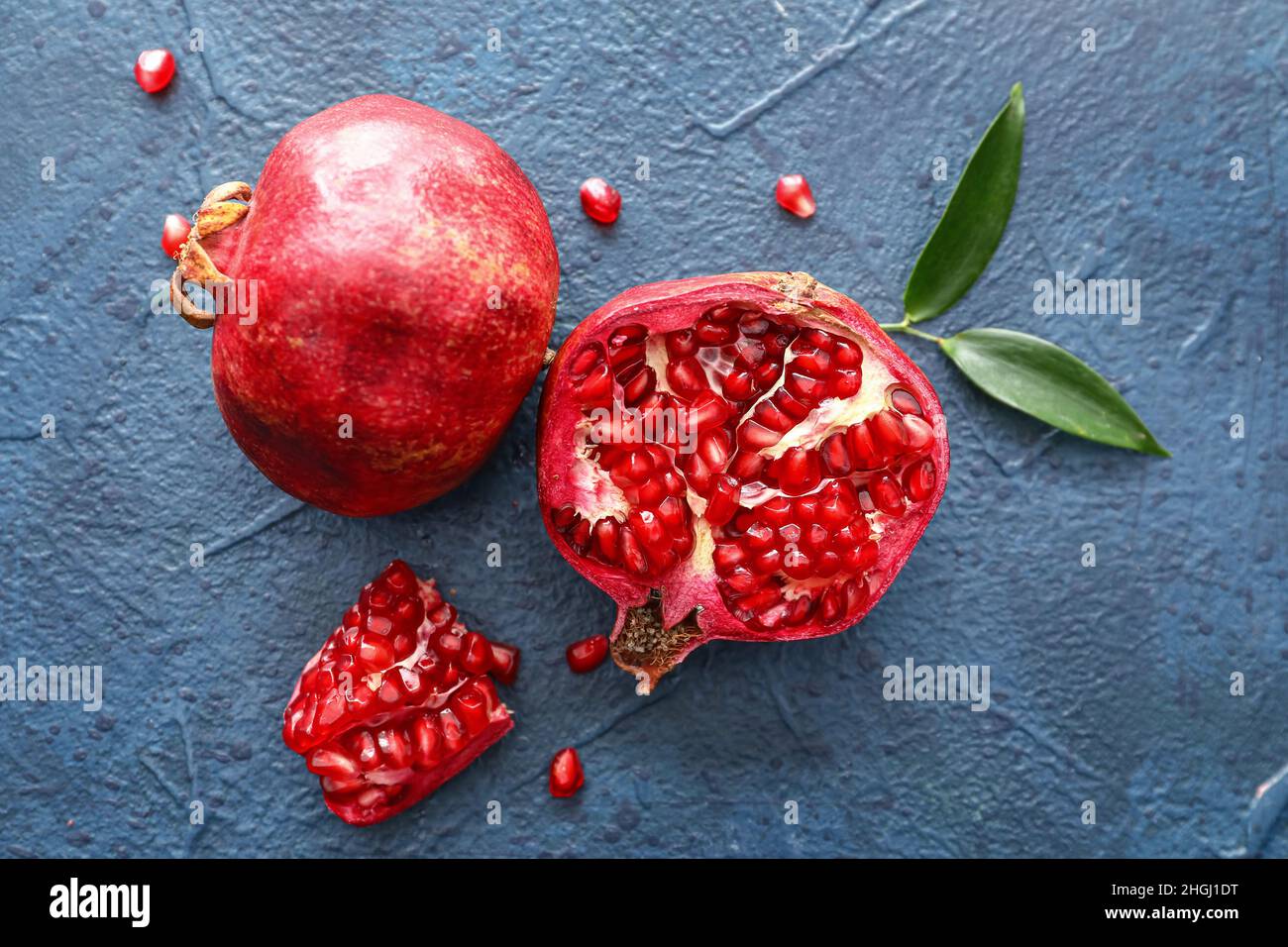 Ripe delicious pomegranates on dark background Stock Photo - Alamy