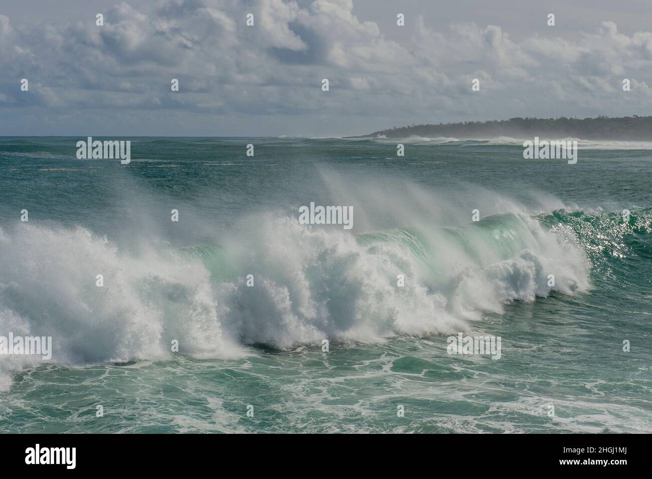 Surf is rolling into Kilauea Bay, located near Kilauea, Kauai, Hawaii ...
