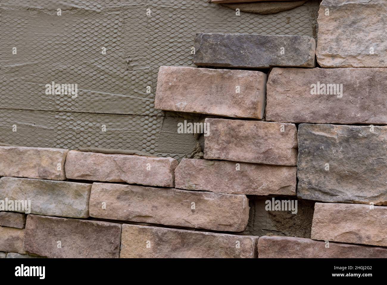 Making texture of wall facing with decorative stone bricks Stock Photo ...