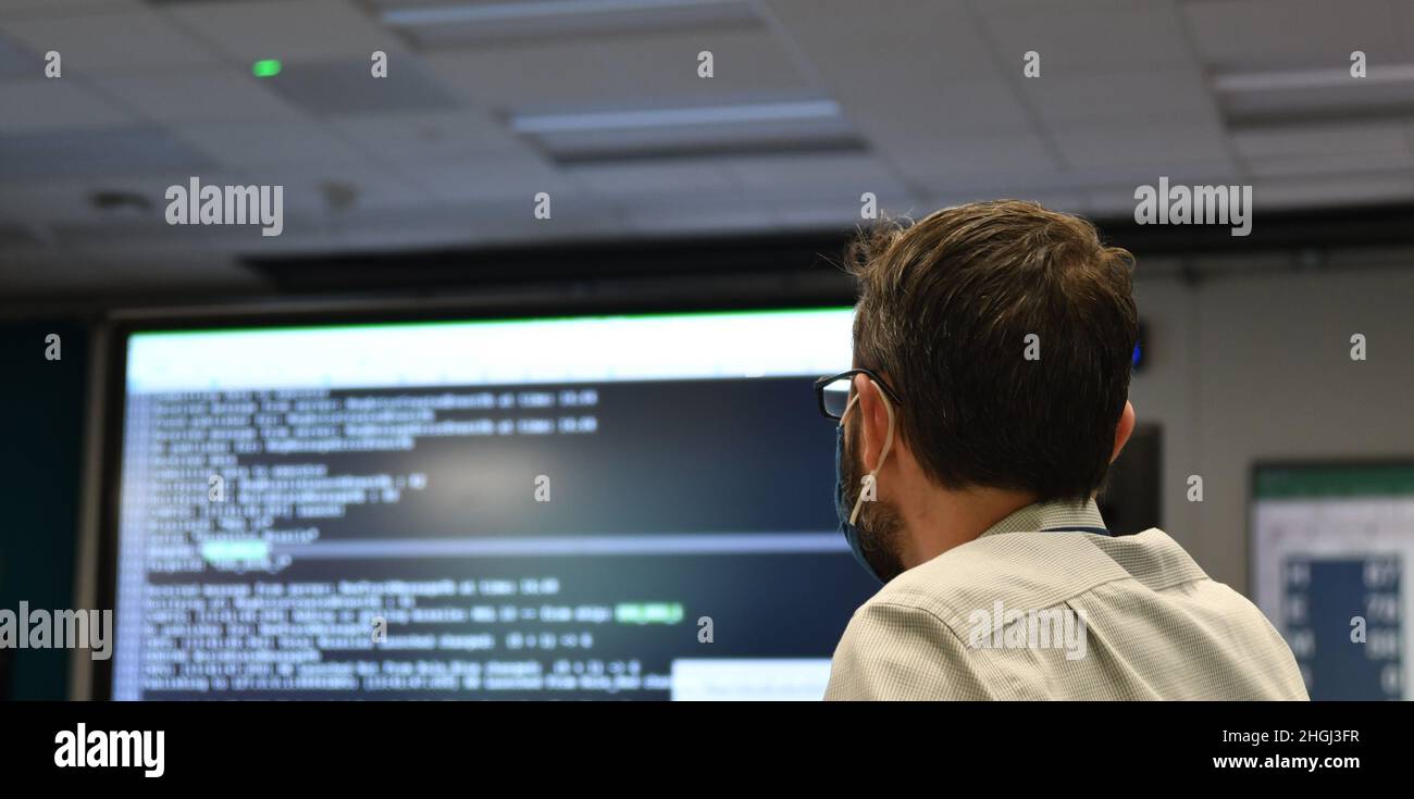 A Naval Surface Warfare Center Dahlgren Division engineer looks on ...
