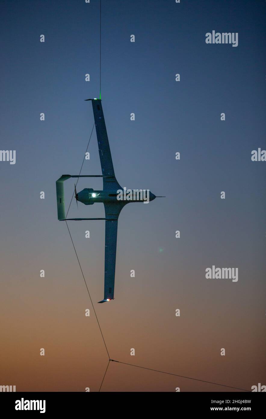 An RQ-21A Blackjack is caught by a cord to safely land the small ...