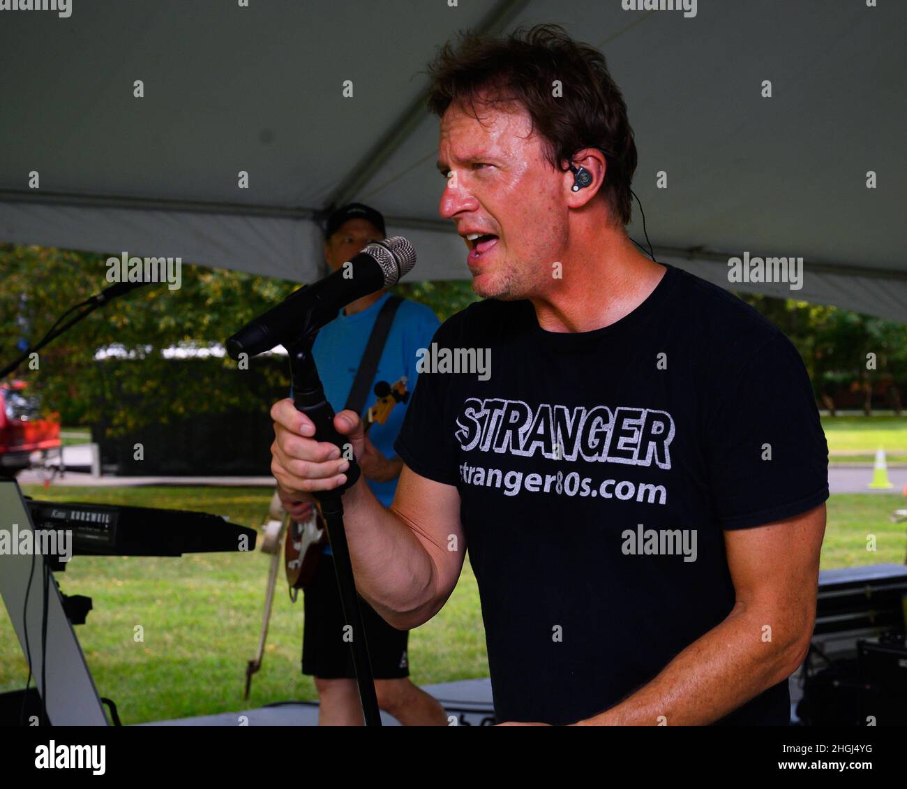 Jeff Stevens, lead singer for Stranger, performs at a block party Aug ...