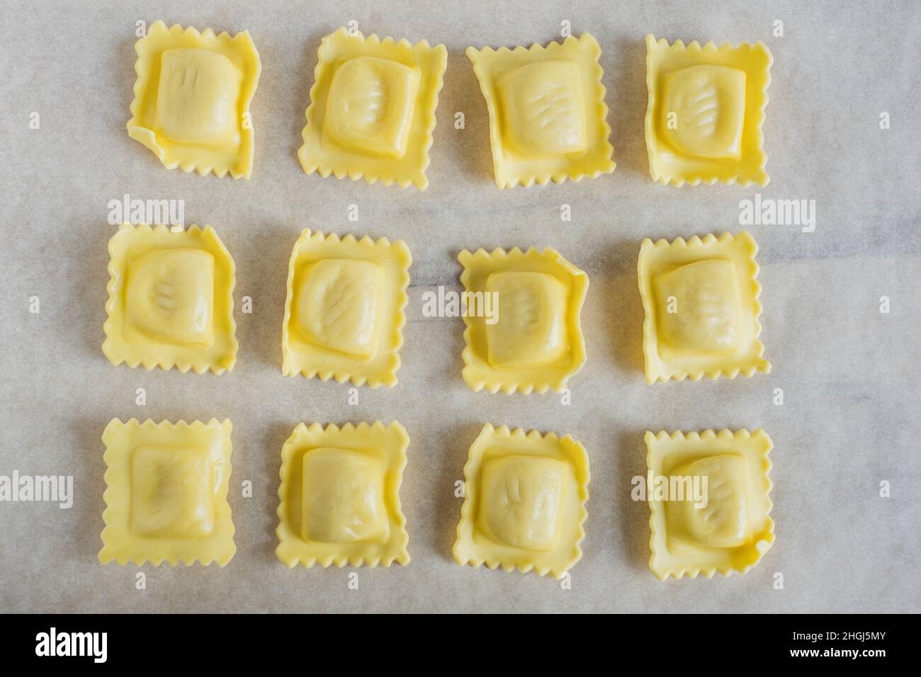 Fresh ravioli pasta top view on light background Stock Photo - Alamy