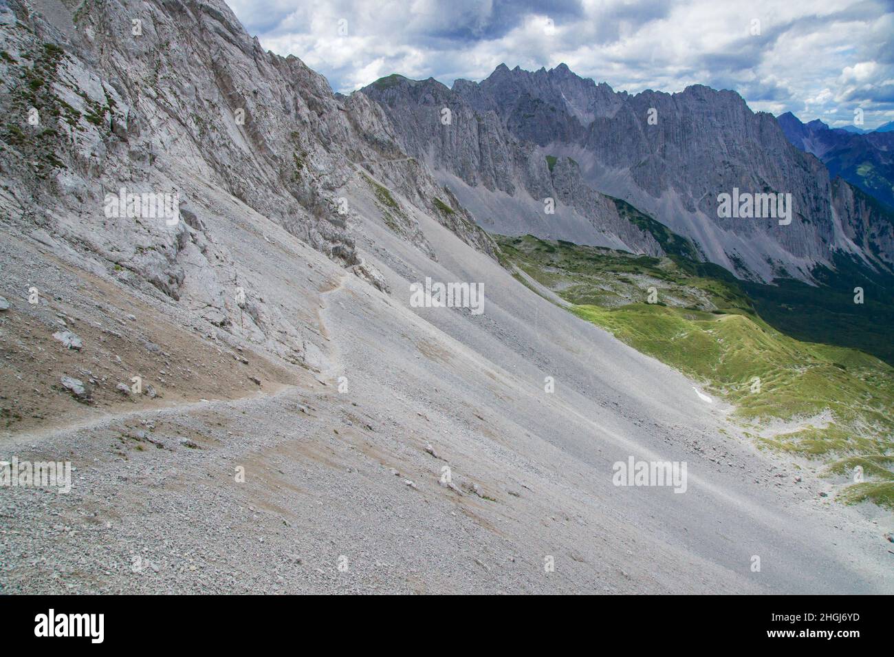 Mountain path between cliffs and screes leads into the distance Stock ...