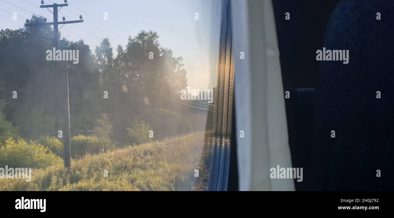 Train movement in the early morning. The sun in the window of the train ...