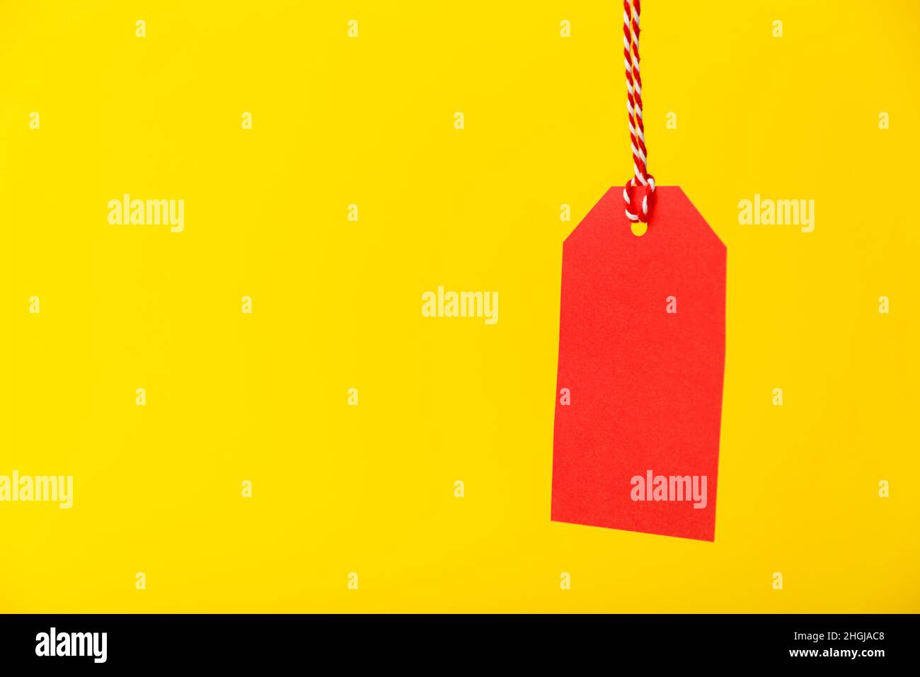 Blank red price tag isolated on yellow background. Black friday, sale ...