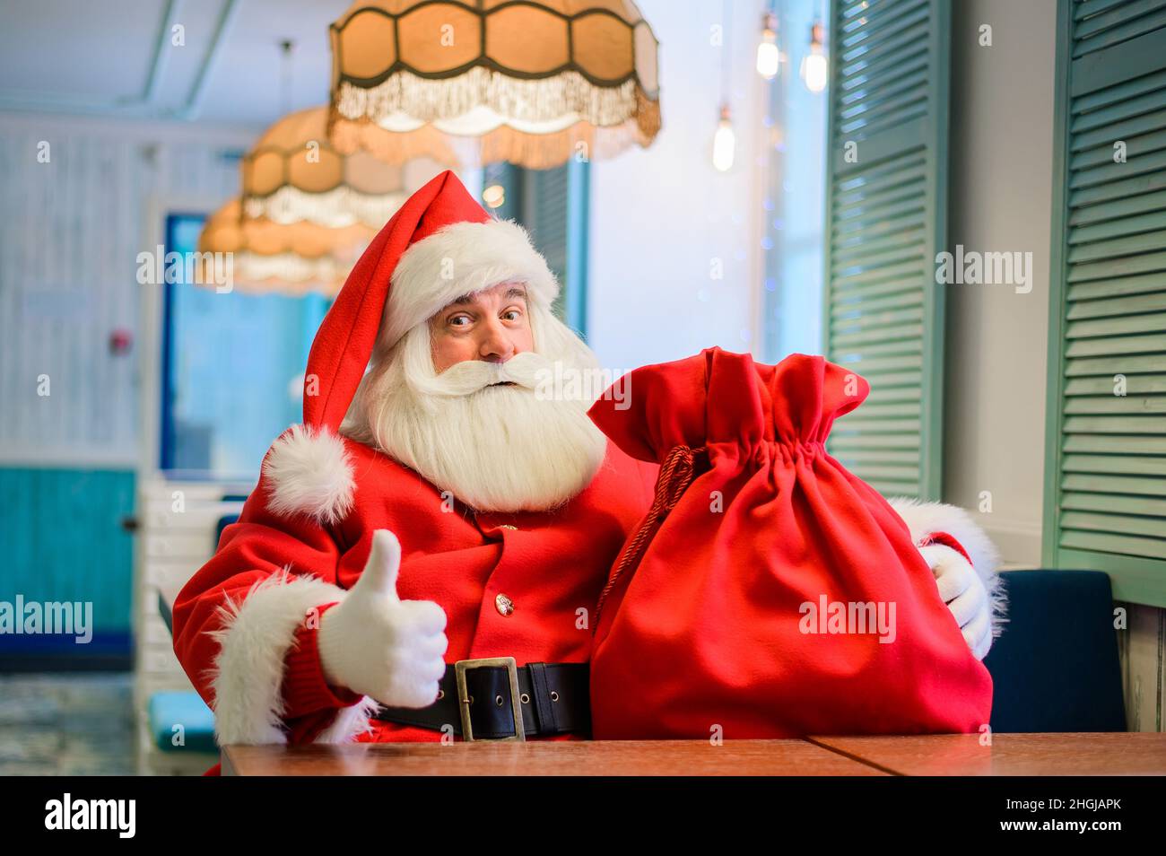 Friendly santa claus in a cafe Stock Photo - Alamy