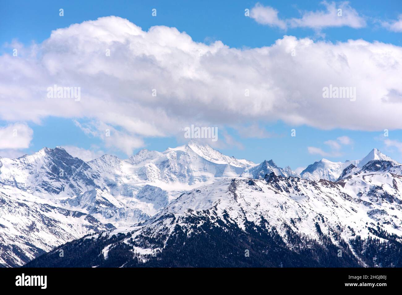 Winter alps landscape, top of the snowy mountains with cloudscape, blue ...