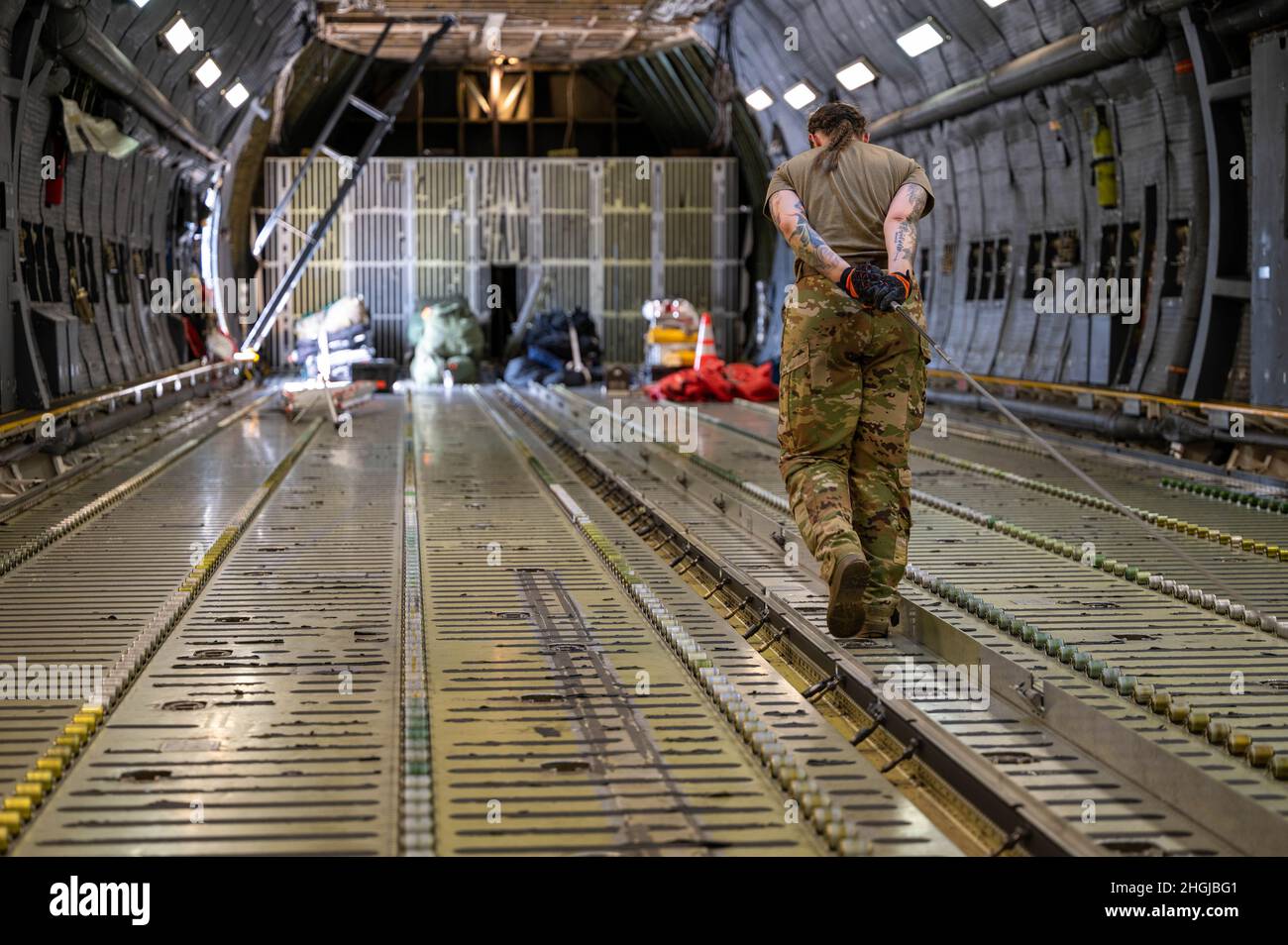 Senior Airman Anna Crocker, 9th Airlift Squadron loadmaster, performs a ...