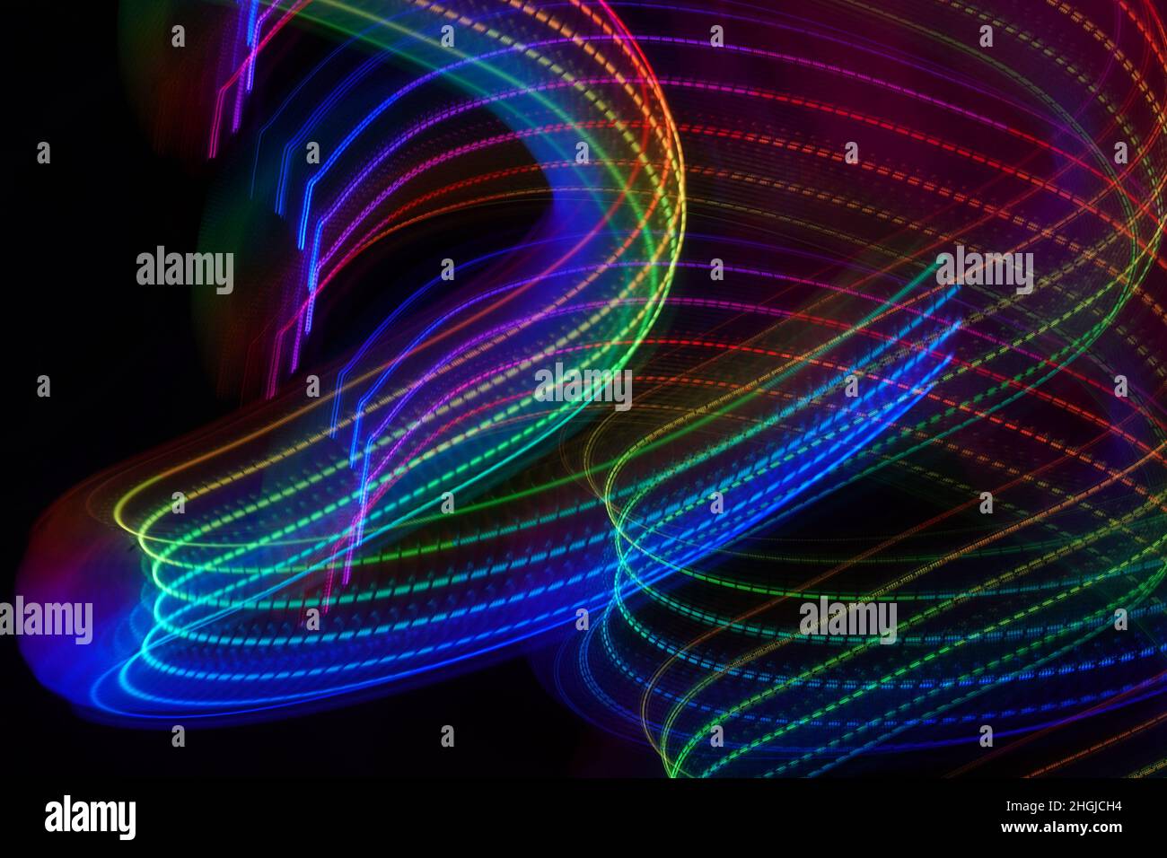 Drawing of a neon line. Abstract lines isolated on a black background ...
