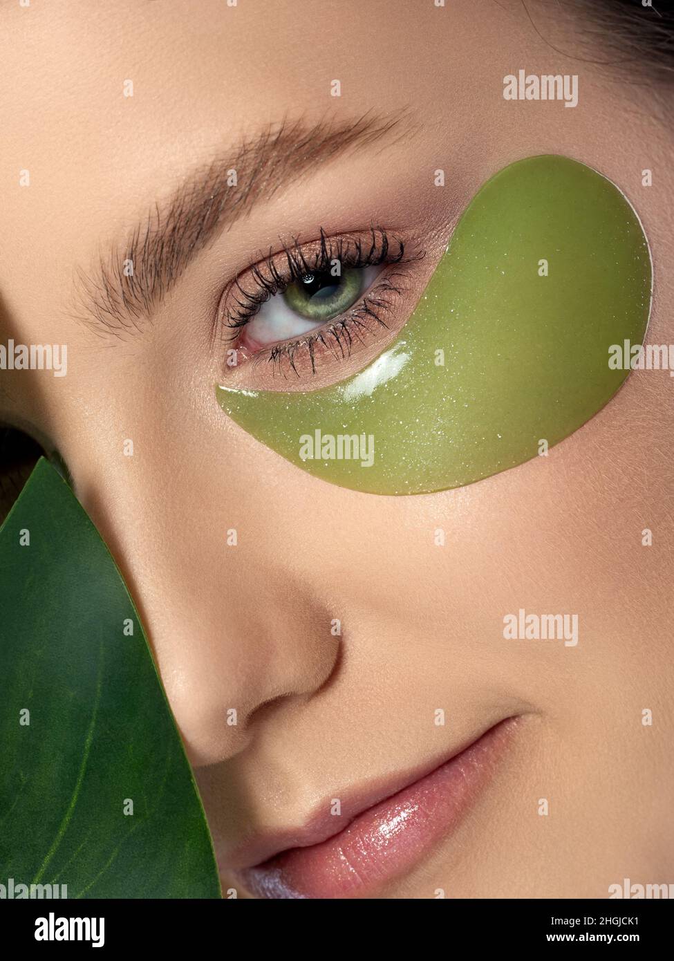 Woman with green eye patches under her eyes Stock Photo - Alamy
